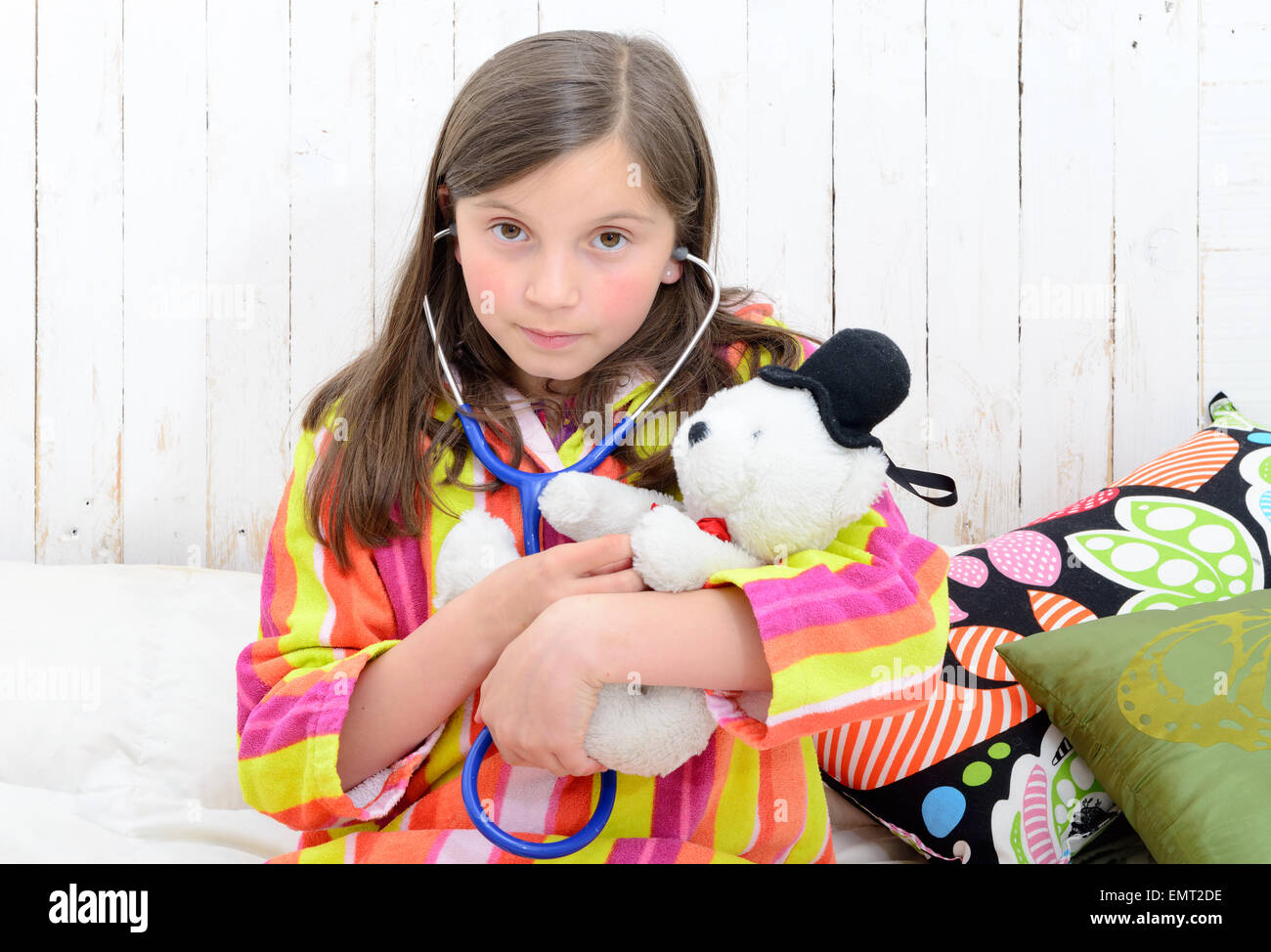 a sick little girl playing with her teddy Stock Photo - Alamy