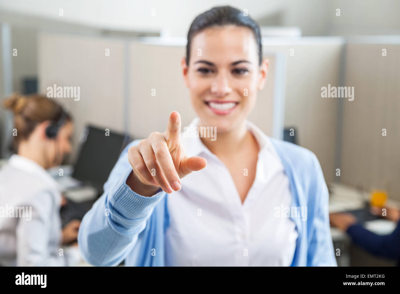 Smiling Female Customer Service Executive Pointing At You Stock Photo ...