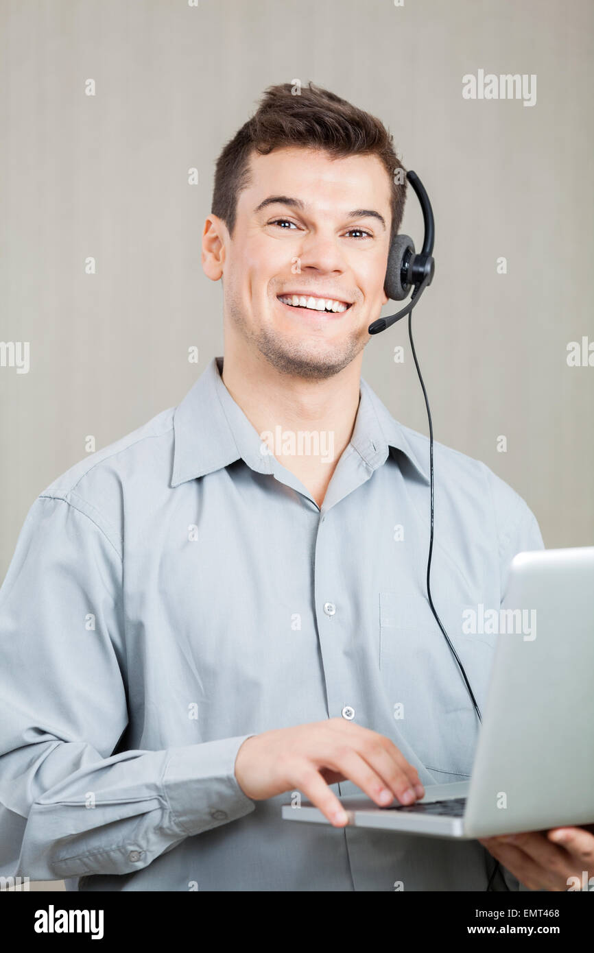 Handsome employee holding laptop hi-res stock photography and images ...