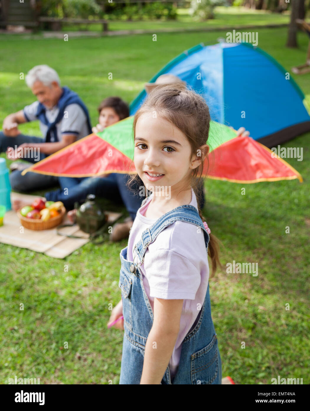 Smiling Girl Standing At Campsite Stock Photo - Alamy