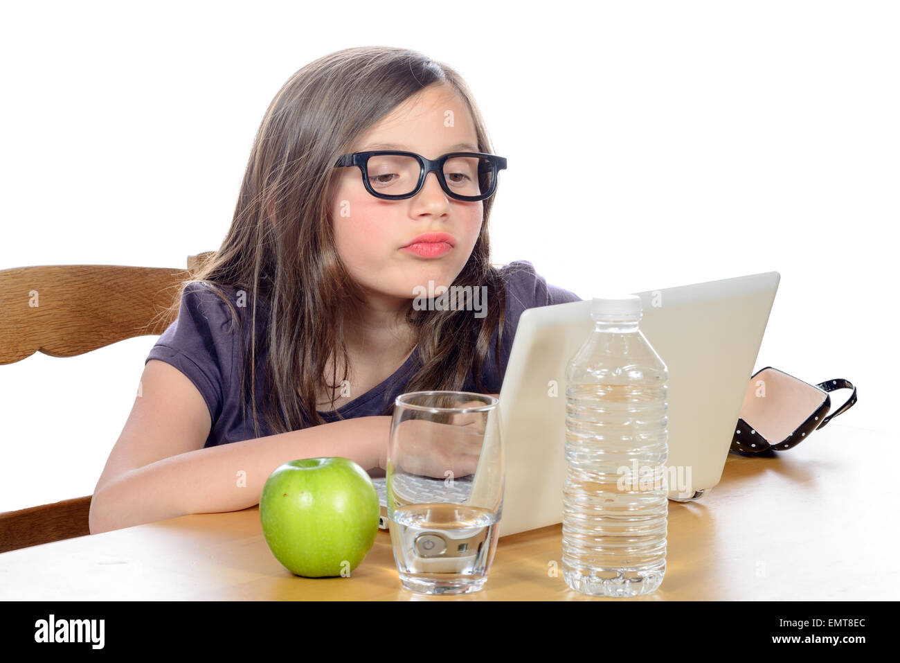 a little girl doing her homework on her computer on white Stock Photo ...