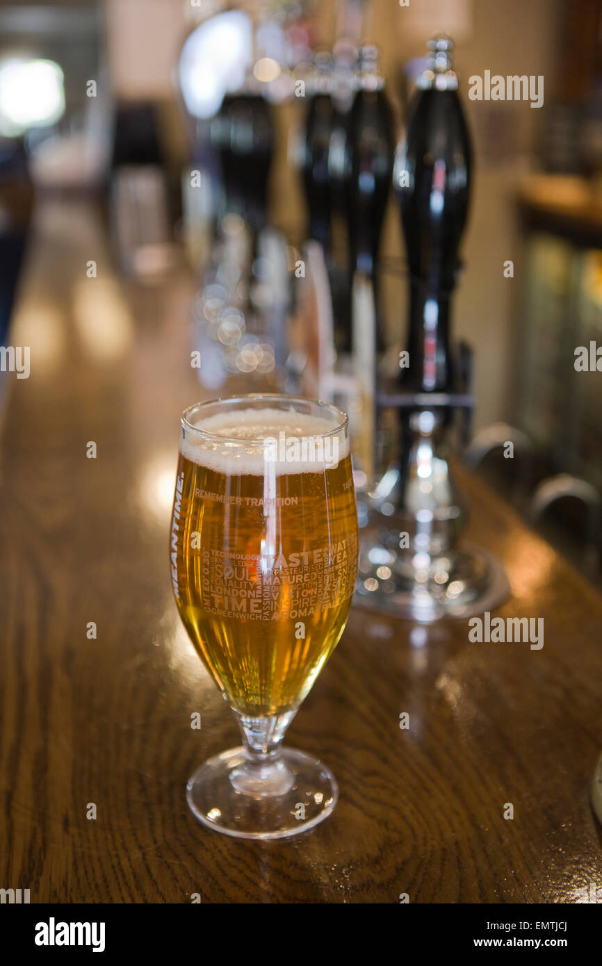 A pint of lager on a bar in a pub Stock Photo - Alamy
