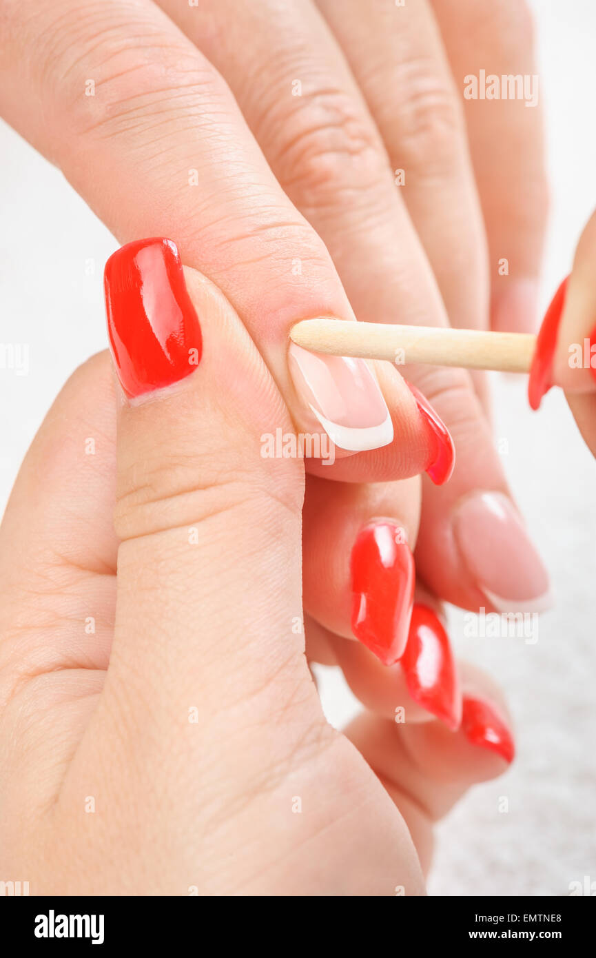 manicure applying - cleaning the cuticles Stock Photo - Alamy