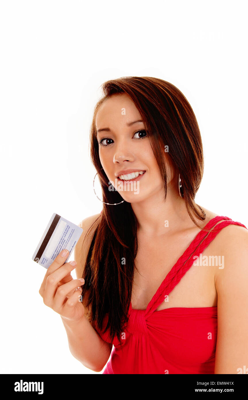 A smiling Asian woman in a red dress holding her credit card, ready for ...