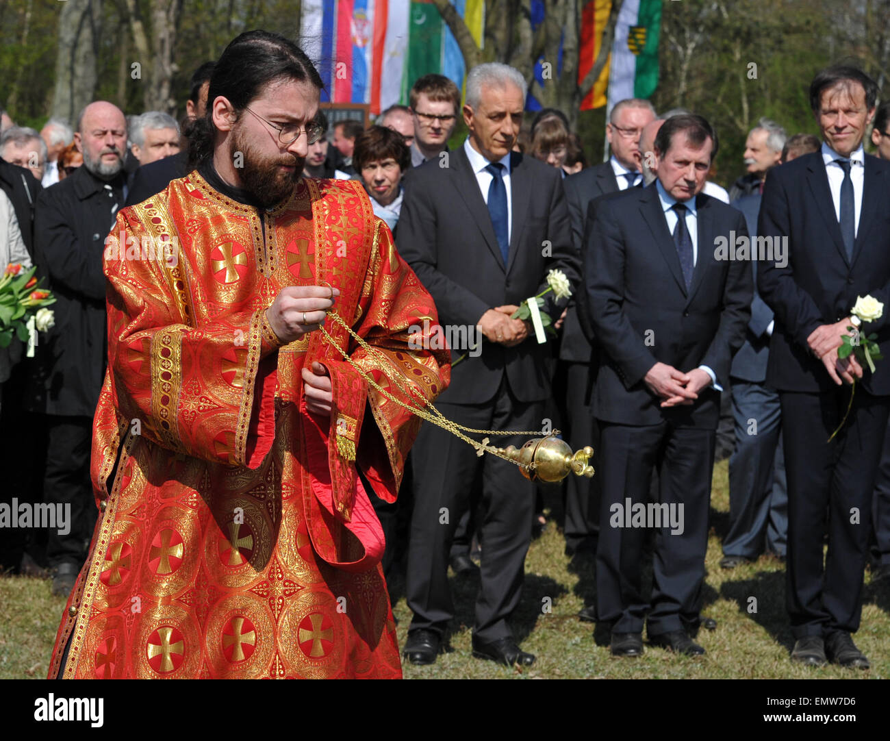 A representative of the Russian Orthodox Church blesses a memorial ...