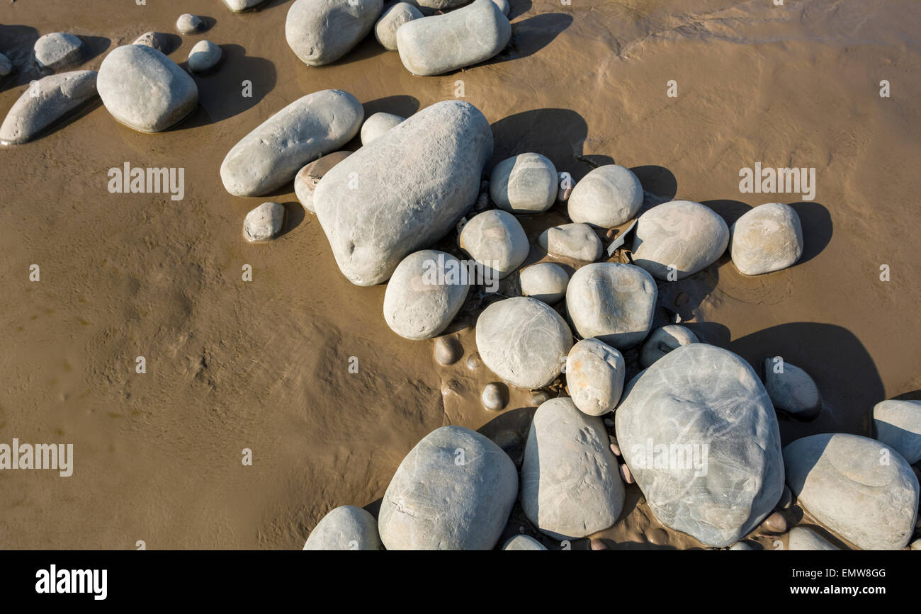 Pebbles of sedimentary rocks make interesting patterns on the beach and ...
