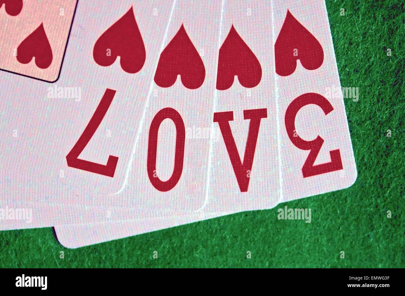 Word love written with heart pips playing cards on green felt Stock ...