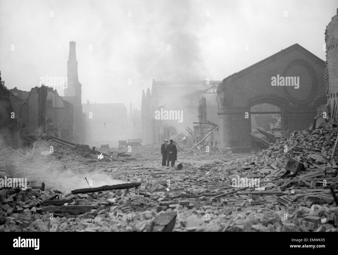 Bomb damage at Liverpool Two people survey the damage caused by the air ...