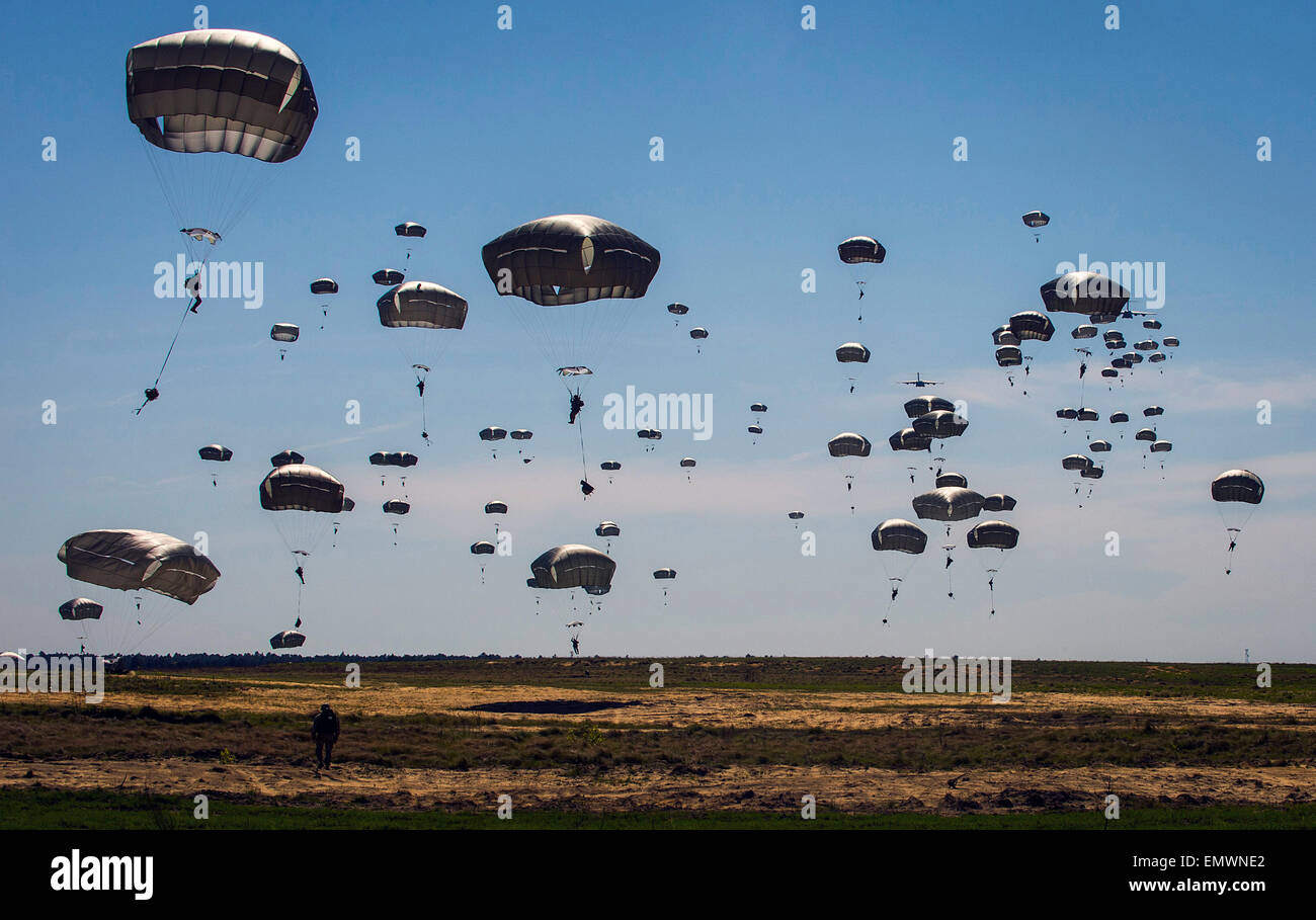 US Army and British paratroopers jump during sunrise at the Holland ...