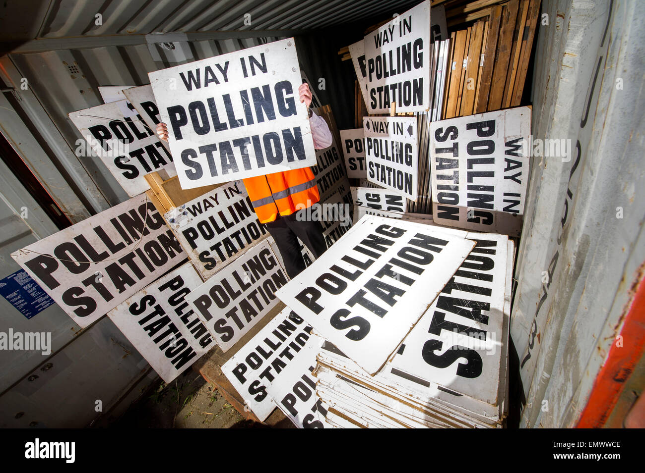 a council official sorts through polling signs and booths in Devon, in ...
