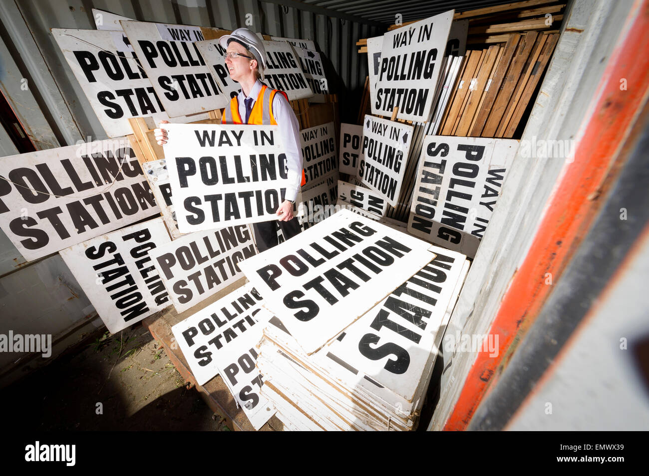 a council official sorts through polling signs and booths in Devon, in ...
