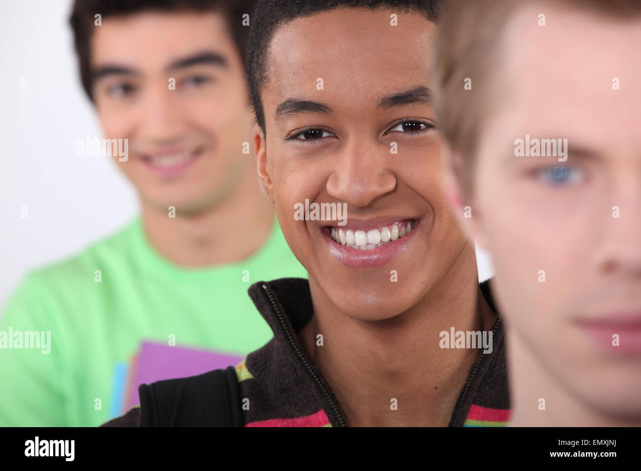Three teenage age friends standing together Stock Photo - Alamy
