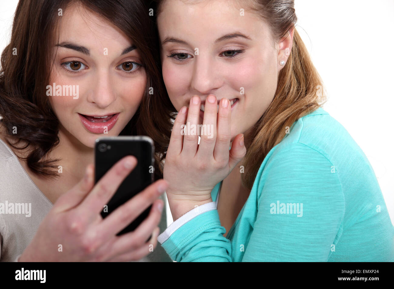 Two girls listen cell phone hi-res stock photography and images - Alamy