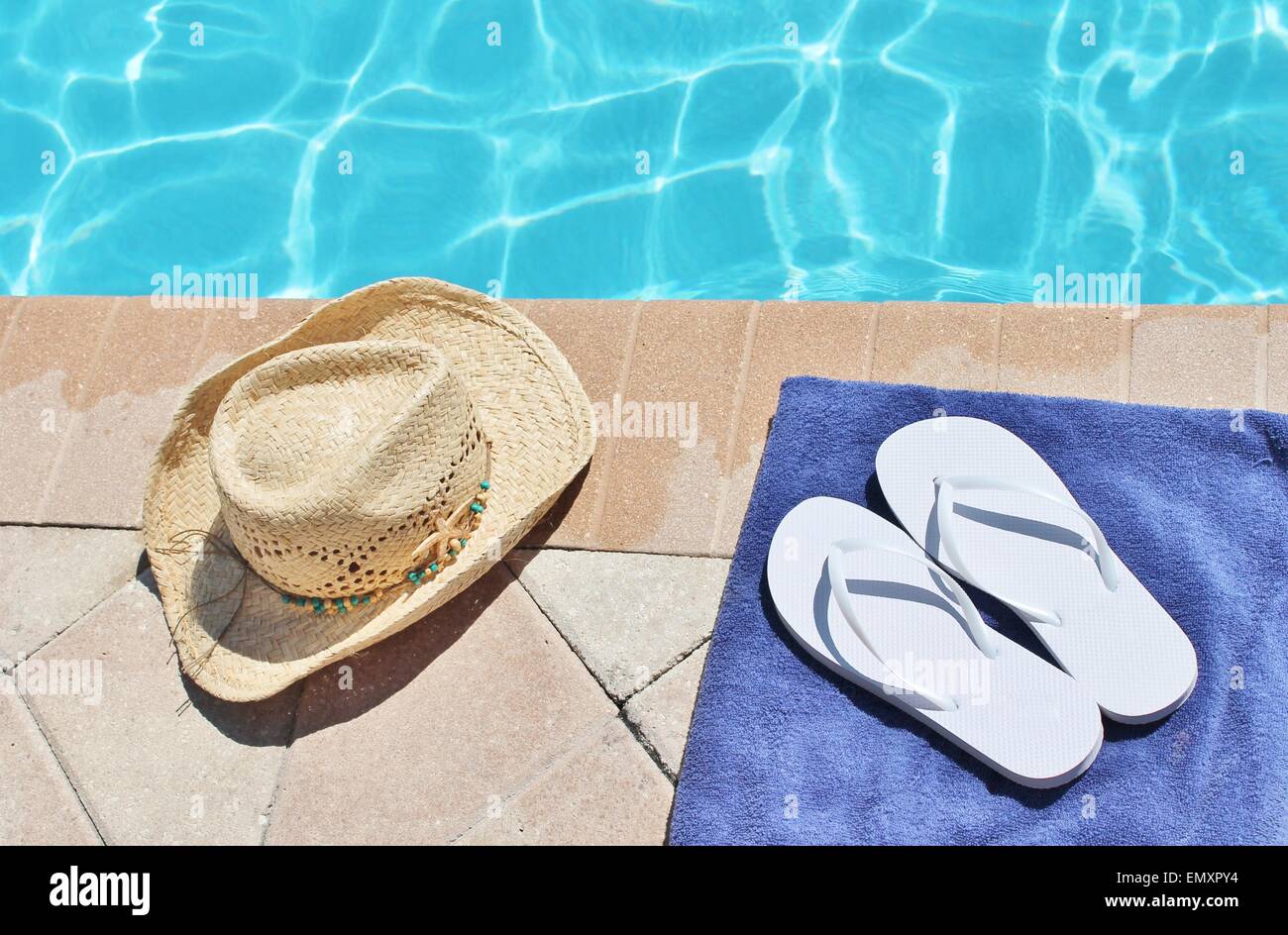 Cowboy hat conch shell towel by swimming pool Stock Photo - Alamy