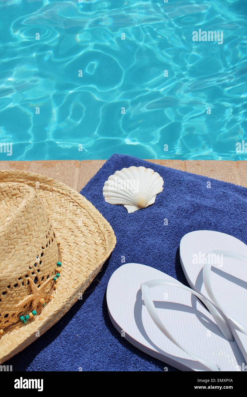 Cowboy hat conch shell towel by swimming pool Stock Photo - Alamy