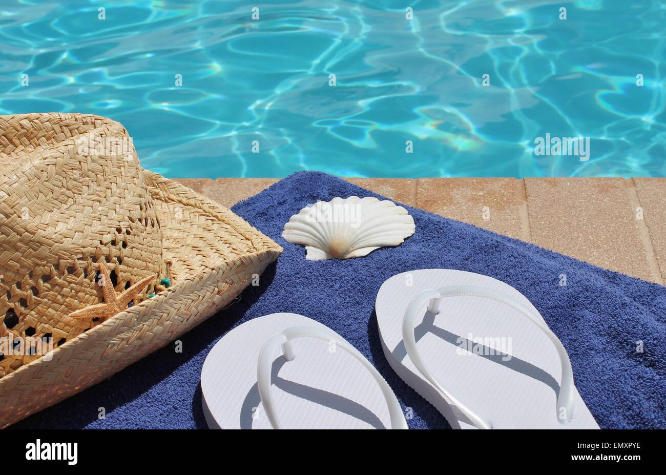 Cowboy hat conch shell towel by swimming pool Stock Photo - Alamy