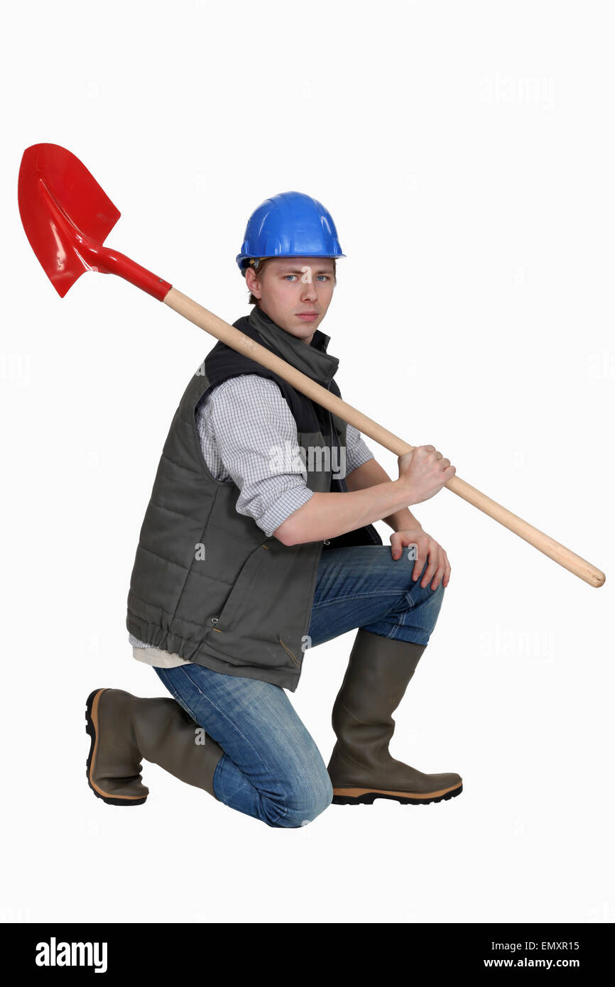 Bricklayer holding shovel Stock Photo - Alamy