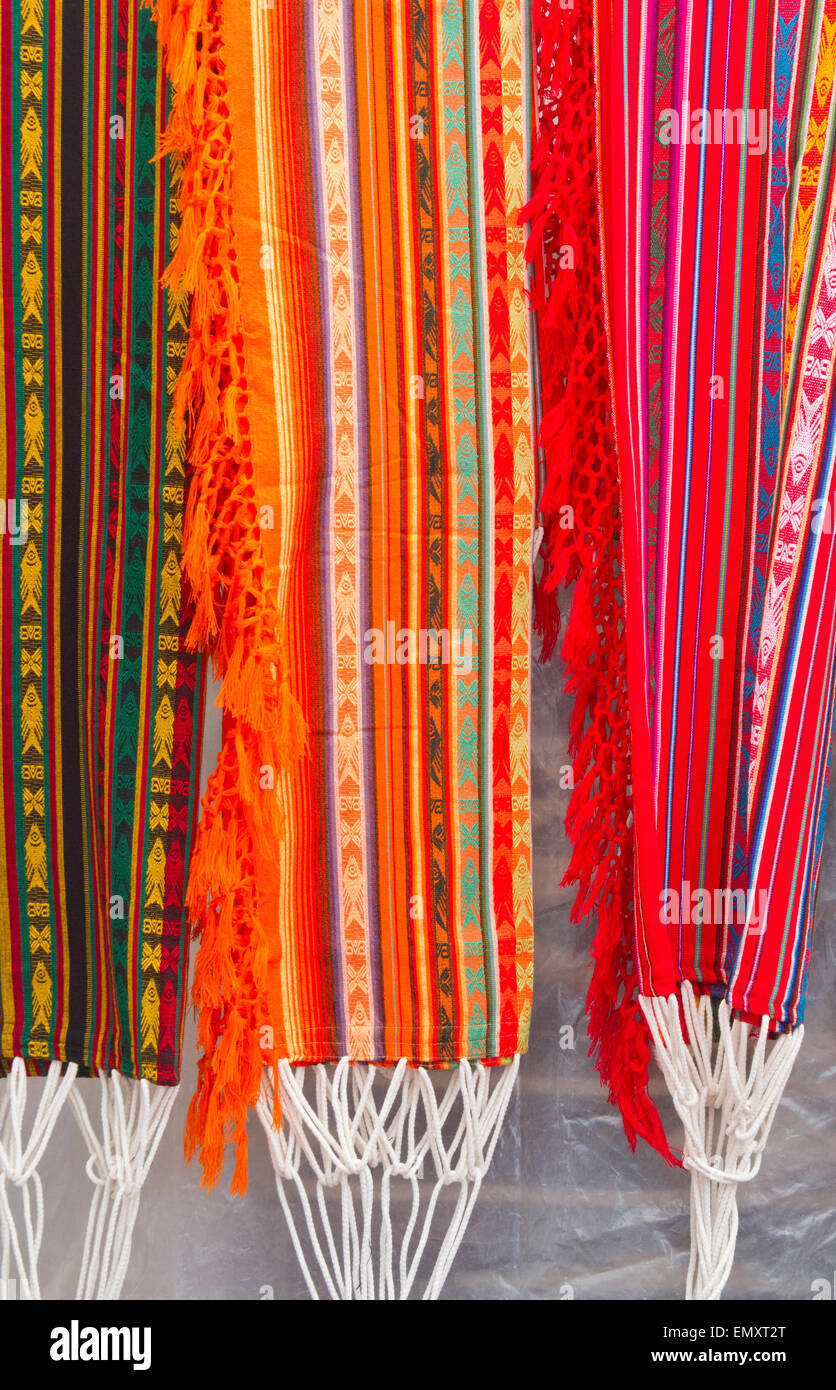 Brightly colored fabrics on display for sale at Otavalo market, Ecuador ...