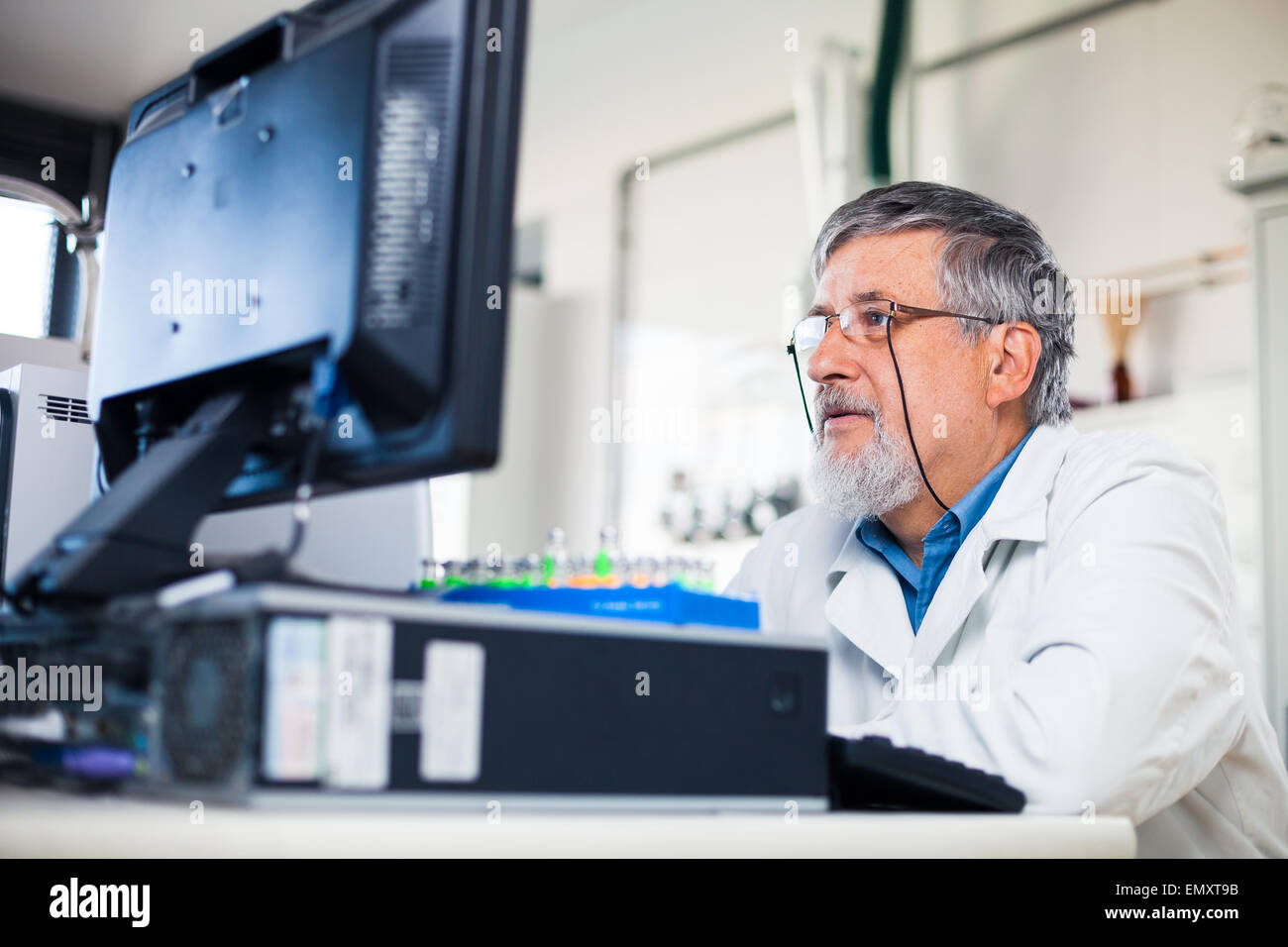 Senior researcher using a computer in the lab while working on an ...