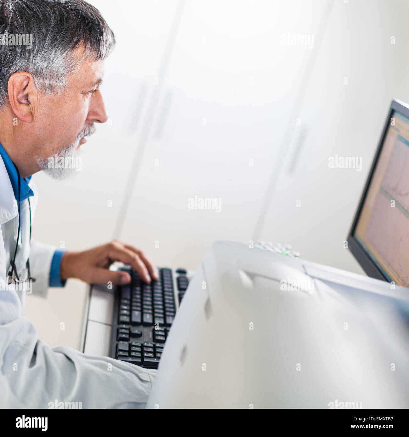 Senior researcher using a computer in the lab while working on an ...