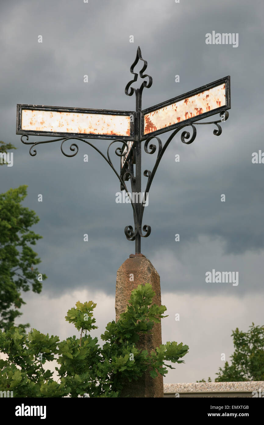 Directional signpost and dramatic sky Stock Photo - Alamy