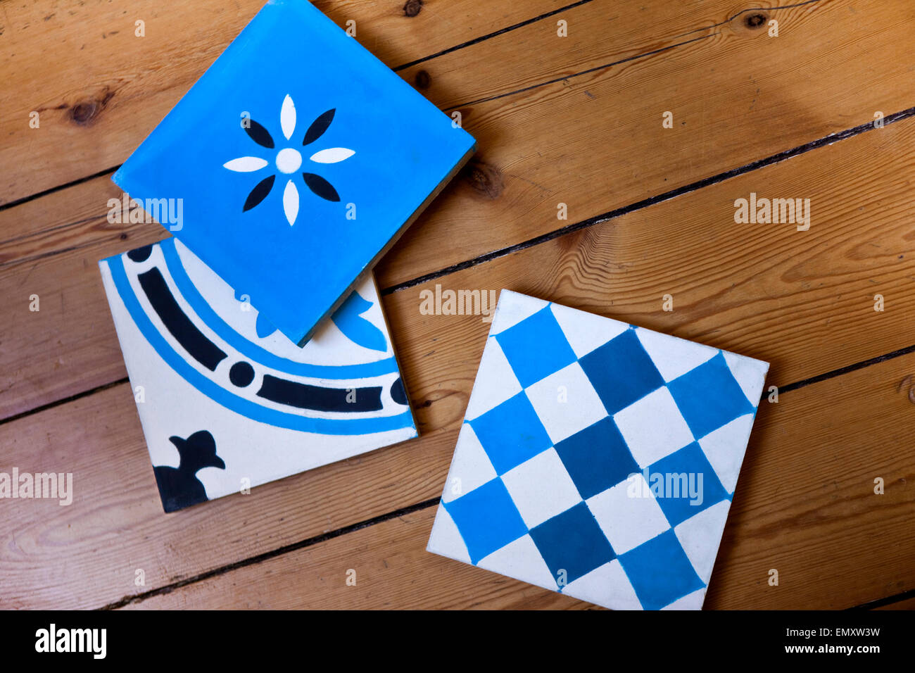 Blue decorative tiles on a wooden floor Stock Photo - Alamy