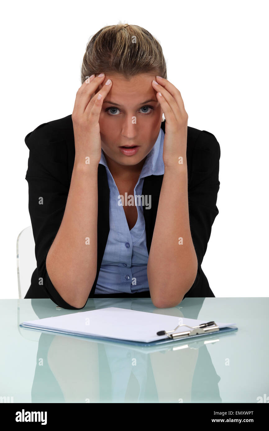 Shocked employee sitting at her desk Stock Photo - Alamy