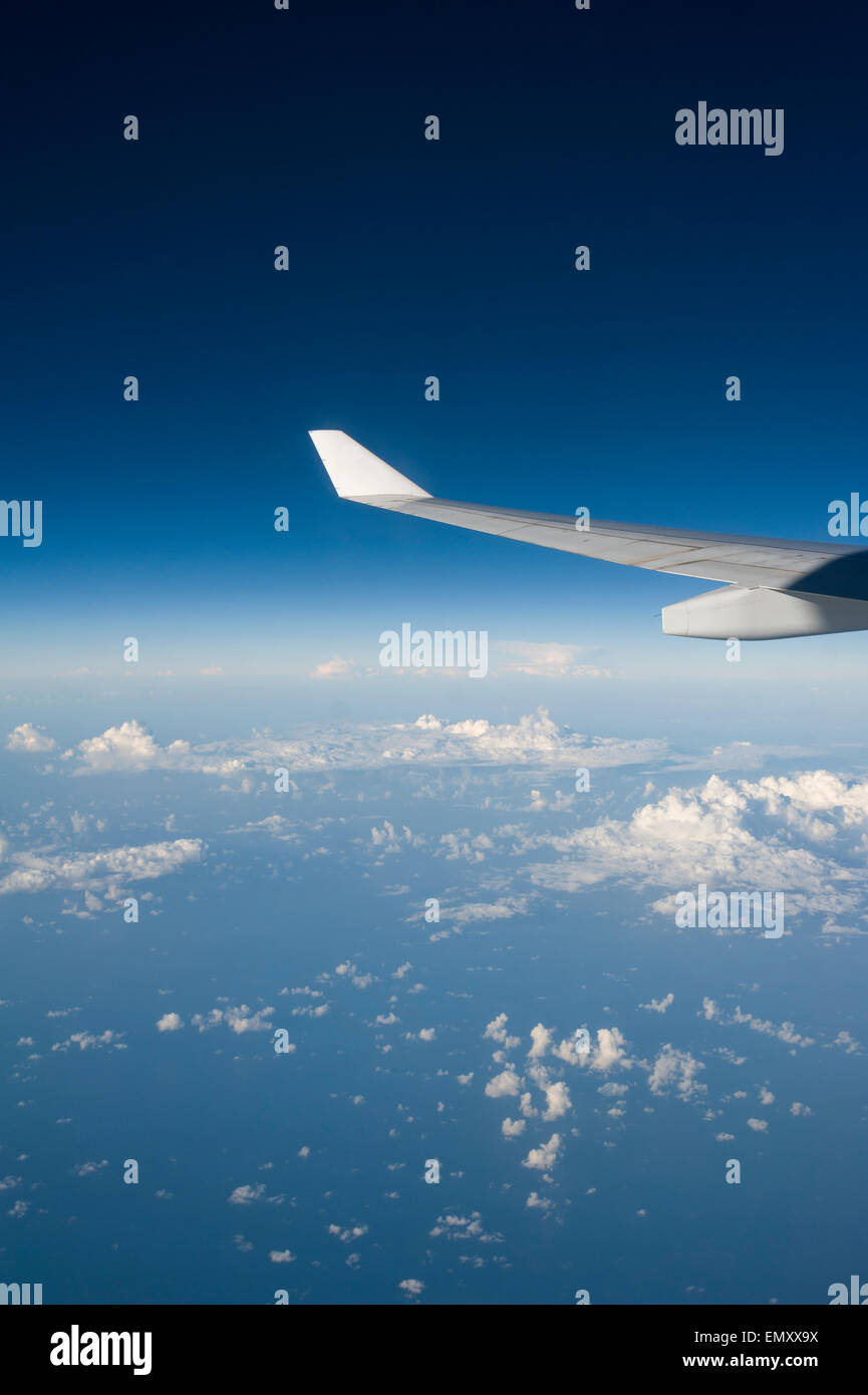 Wing seen through airplane window at high altitude Stock Photo - Alamy