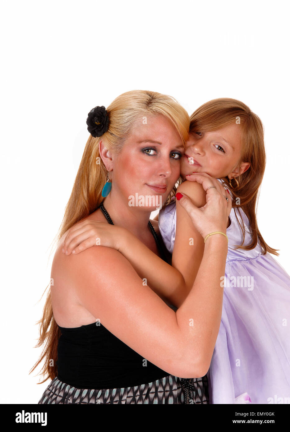 A lovely picture a mother hugging her little daughter, looking into the camera, isolated for ...