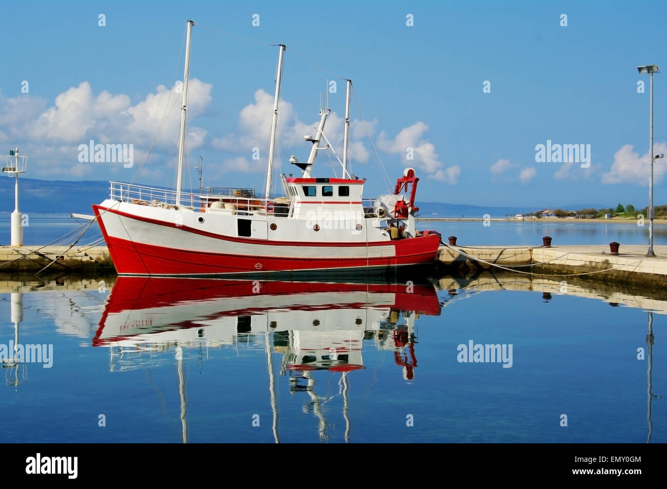 Wooden red fishing boat in harbor Stock Photo - Alamy