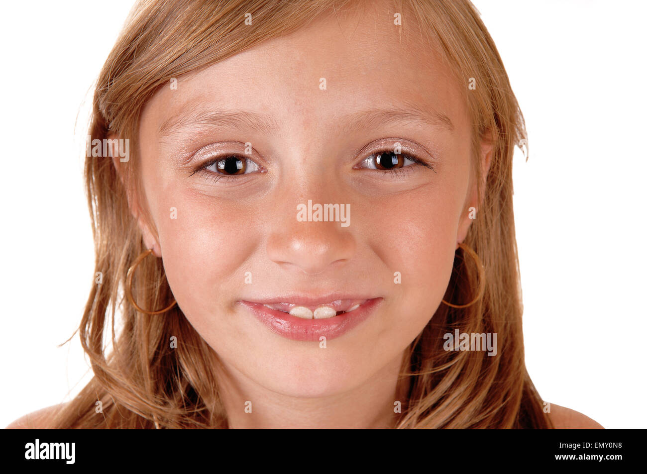 A closeup picture of the face of a eight year old girl, smiling ...