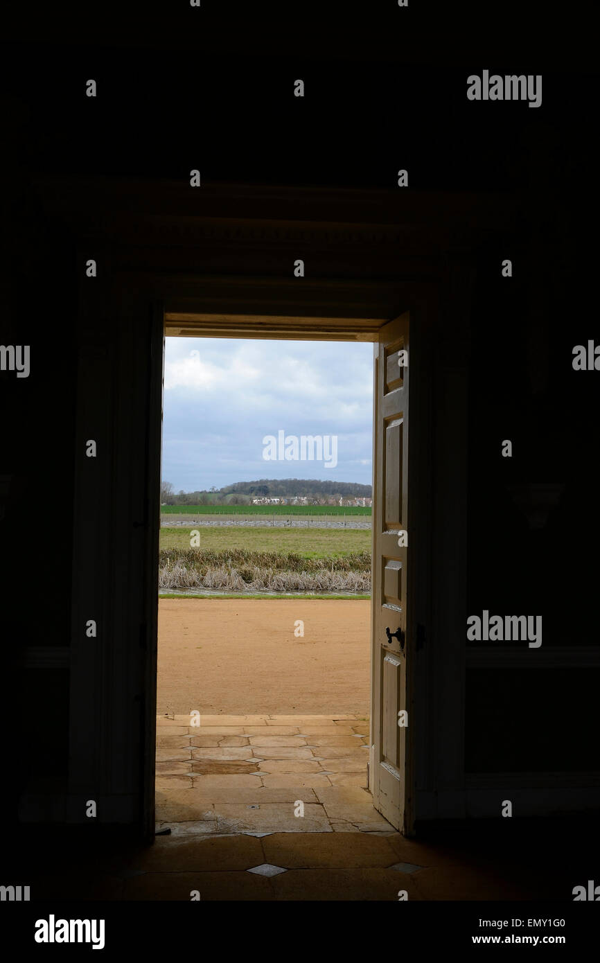 Doorway letting in light to a dark room Stock Photo - Alamy