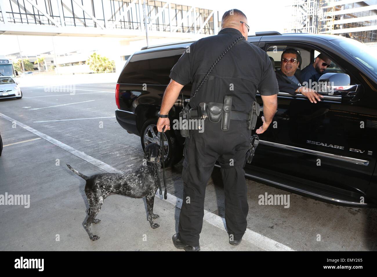 George Lopez smiles as he arrives at LAX as Police and Police dog say ...