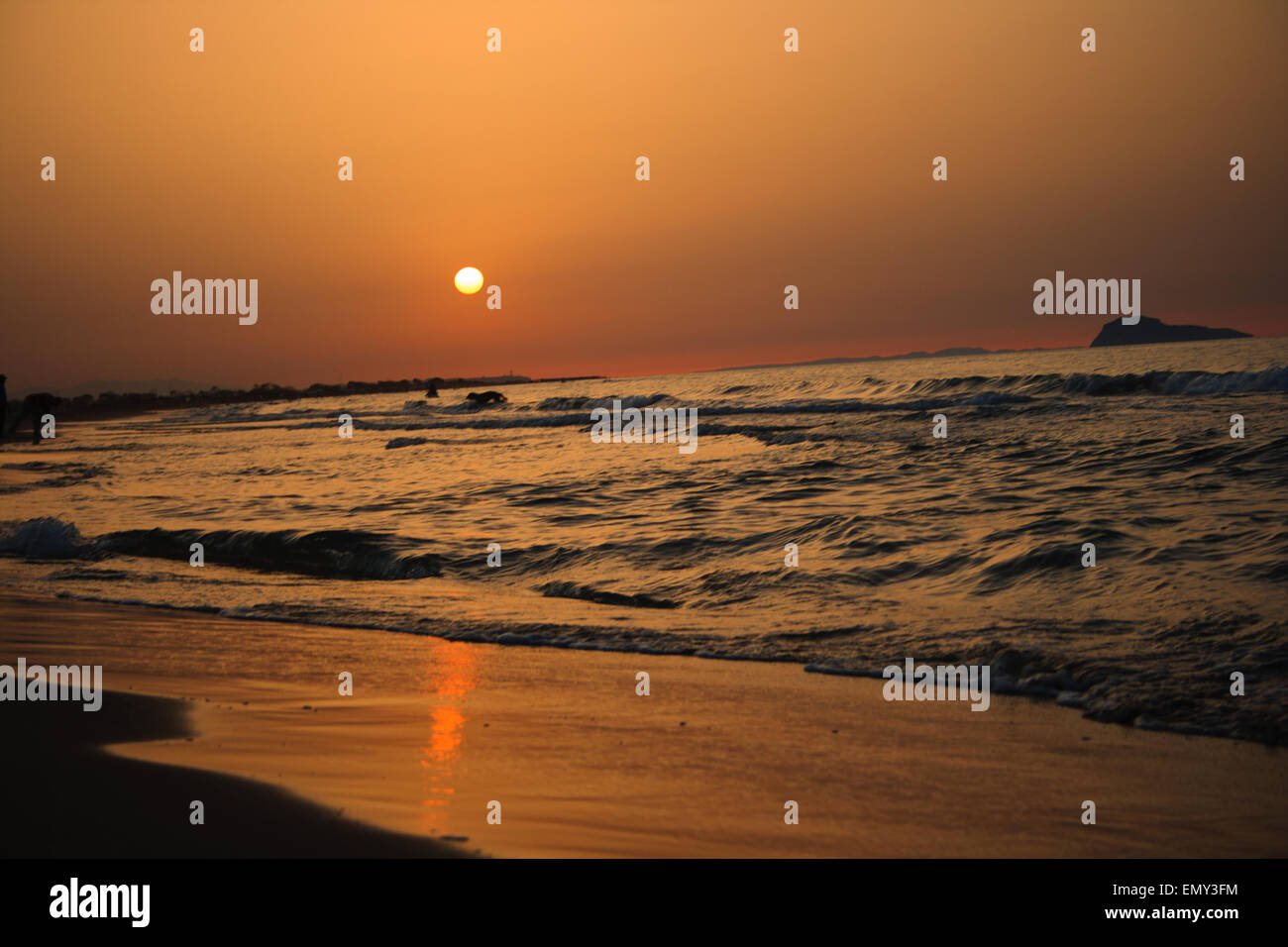 Golden sunset view on the beach Stock Photo - Alamy