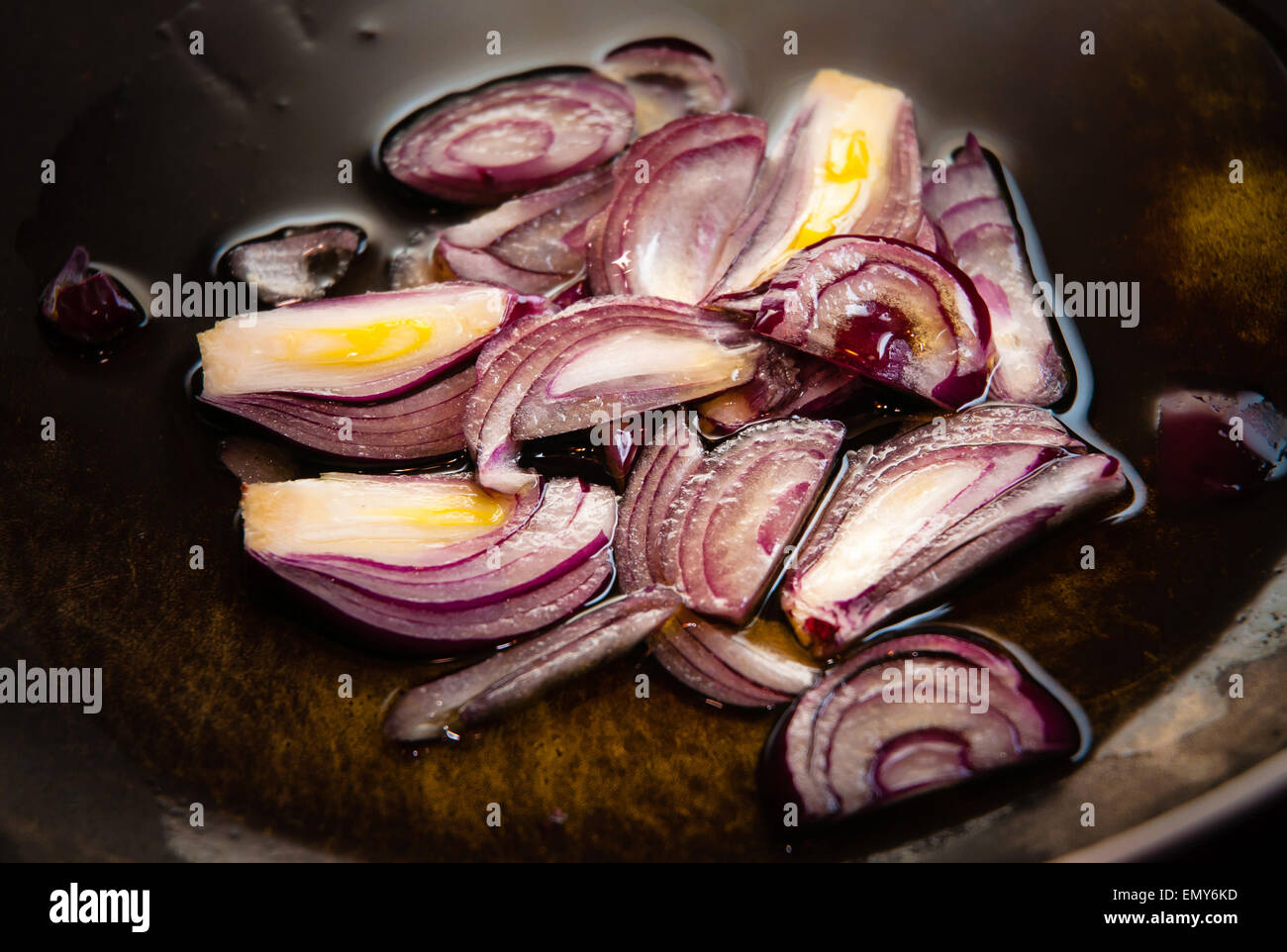 Close up of red onions frying in oil, in a pan Stock Photo - Alamy