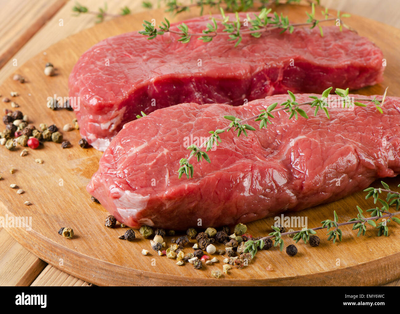 Raw beef steak on a cutting board. Selective focus Stock Photo - Alamy