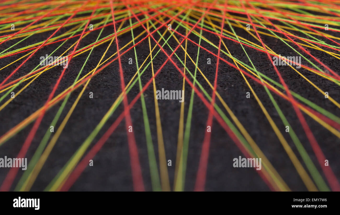 Display of colorful threads on a black panel Stock Photo - Alamy