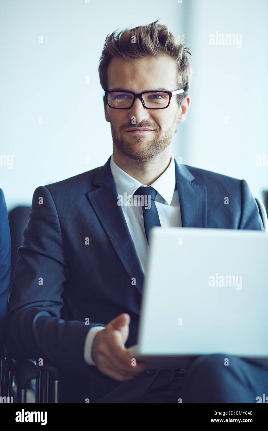 Elegant employee with laptop during meeting Stock Photo - Alamy