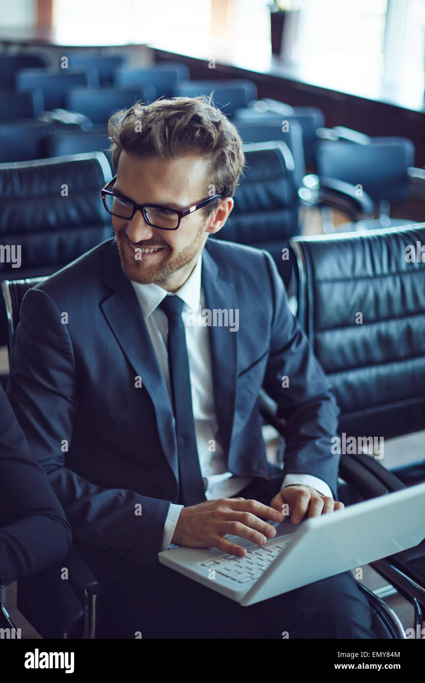 Male employee typing while listening to colleague at meeting Stock ...