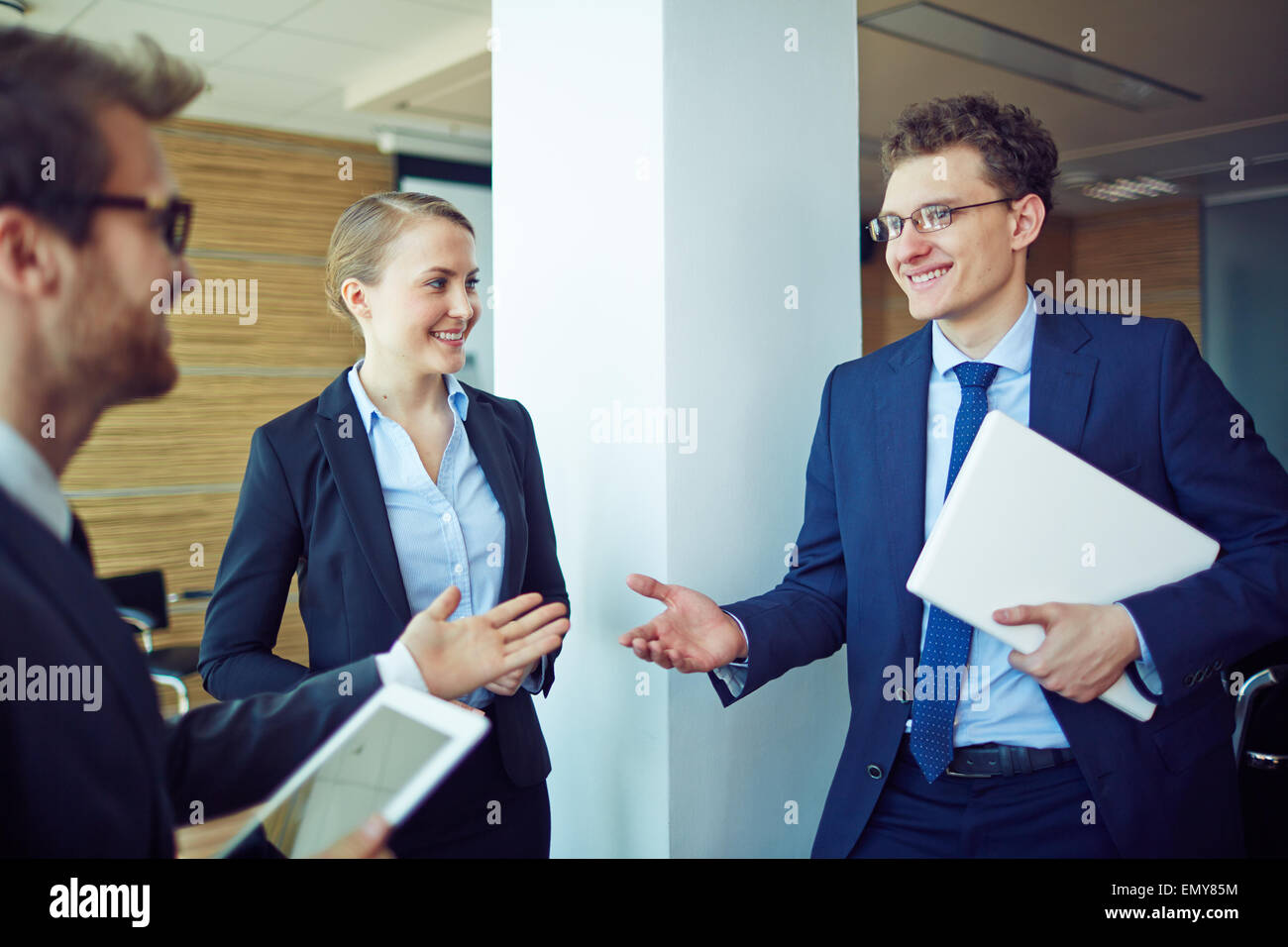 Group of managers interacting in conference hall at break Stock Photo ...
