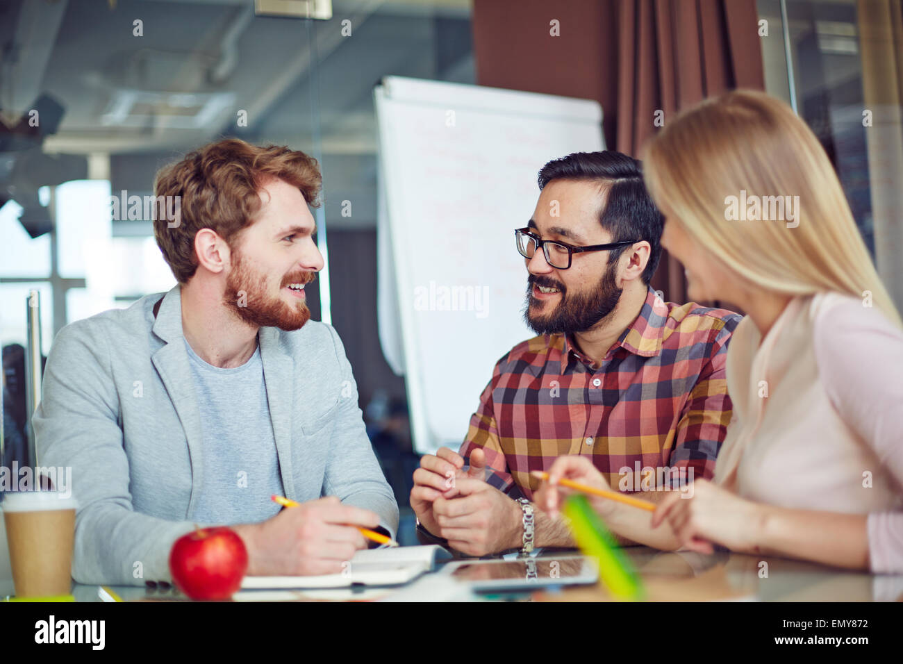 Three colleagues interacting about new strategies Stock Photo - Alamy