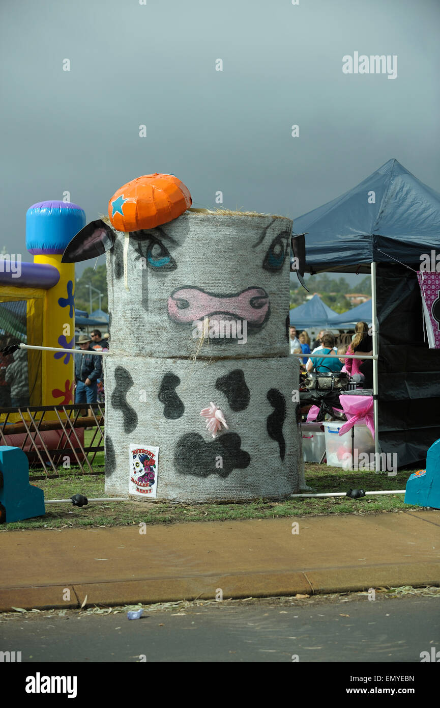 Round haystacks decorated as a cow Stock Photo - Alamy