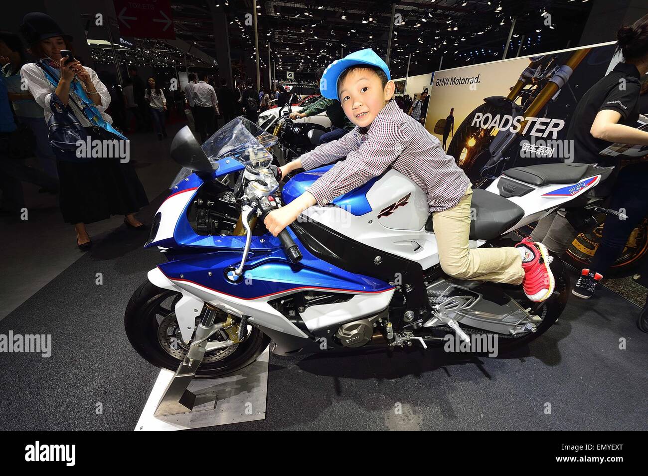 Shanghai, China. 23rd April, 2015. A little Chinese kid rides a new BMW ...