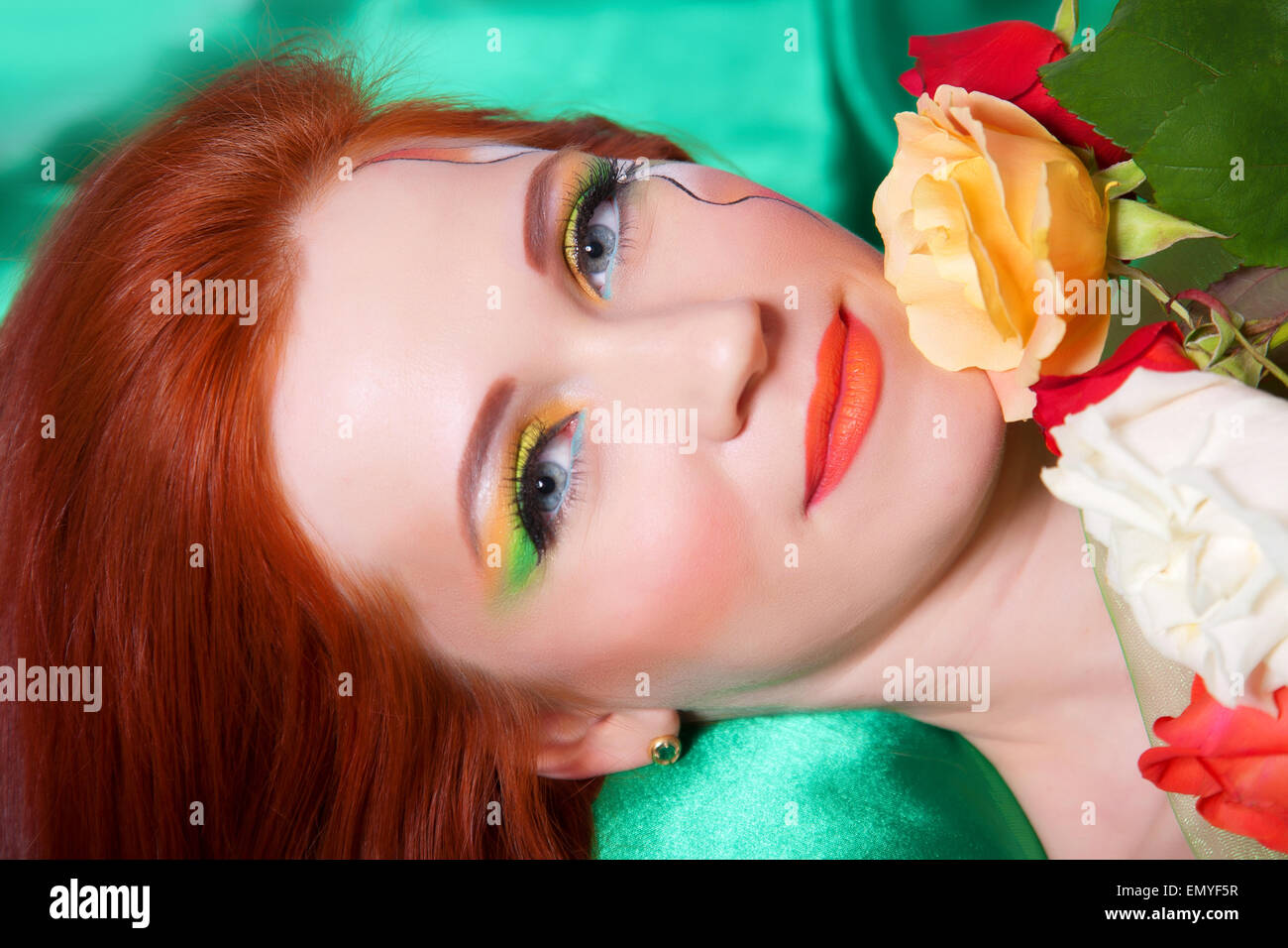 Portrait Of Beautiful Red Haired Girl With Flowers And Bright Makeup