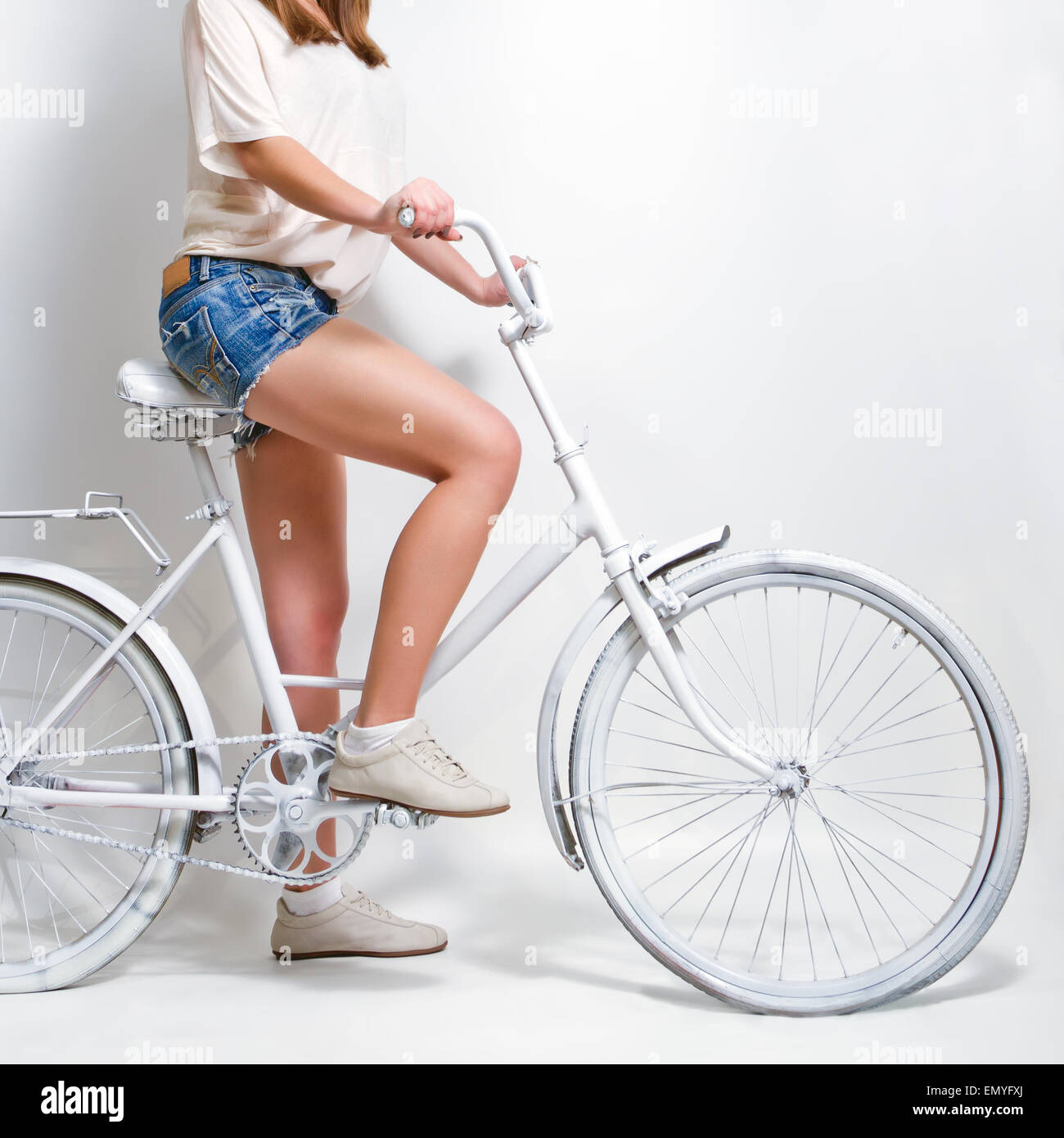 Young woman riding a white vintage bicycle Stock Photo - Alamy