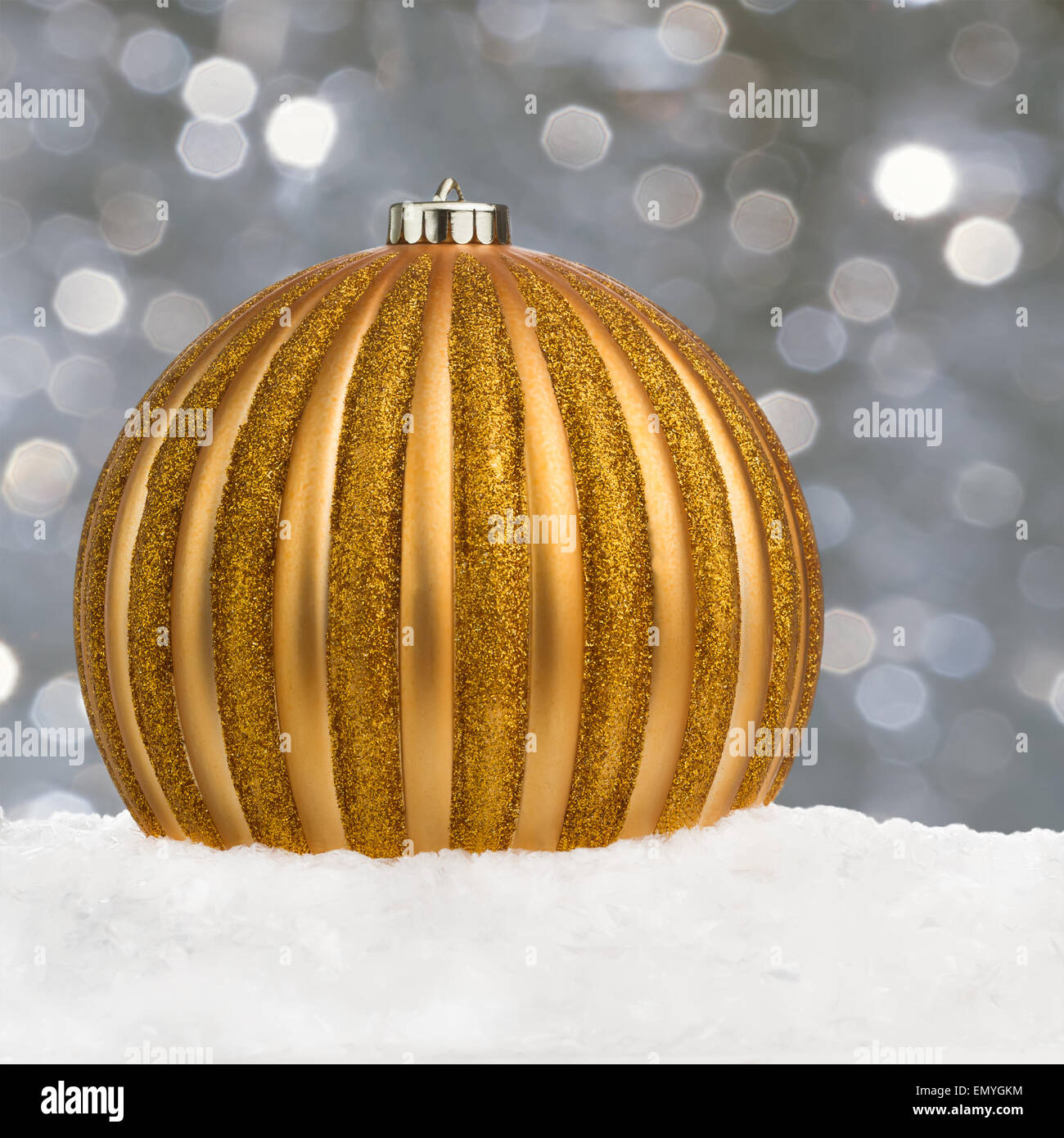 Big golden Christmas ball on snow over festive defocused backgro Stock ...