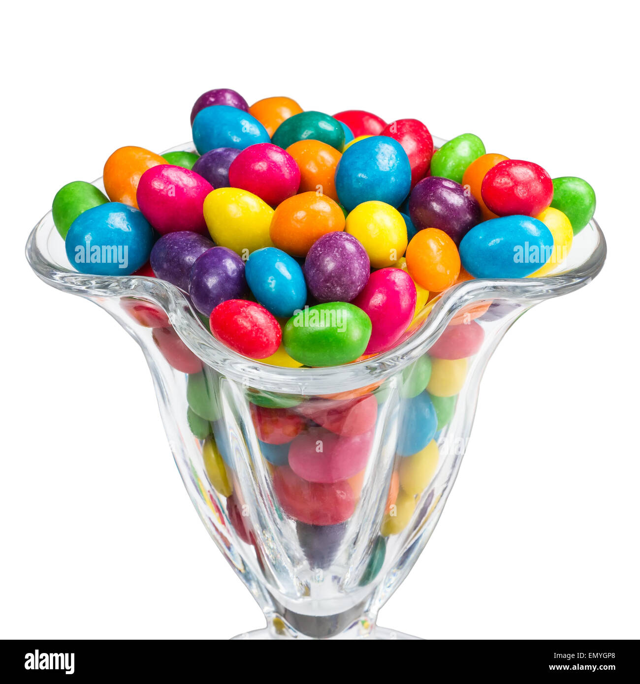 Transparent glass full of sweet colorful candy against a white b Stock ...