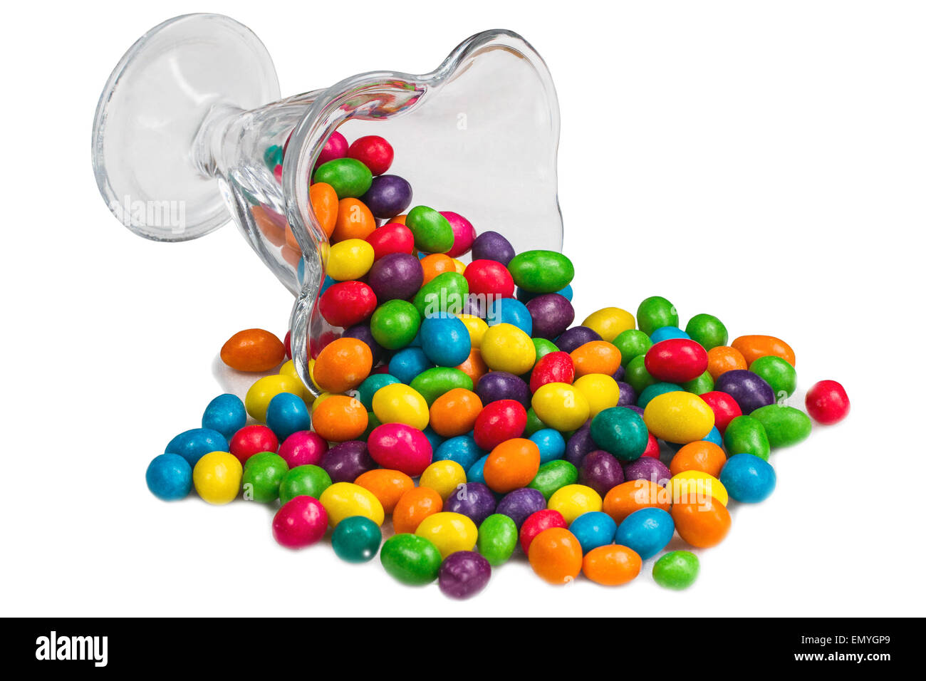 Transparent glass full of sweet colorful candy against a white b Stock ...