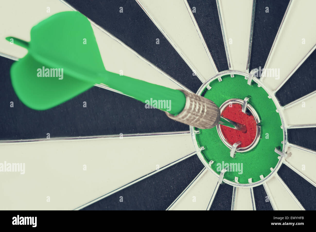 Darts hitting a target close-up. Vintage filtered Stock Photo - Alamy