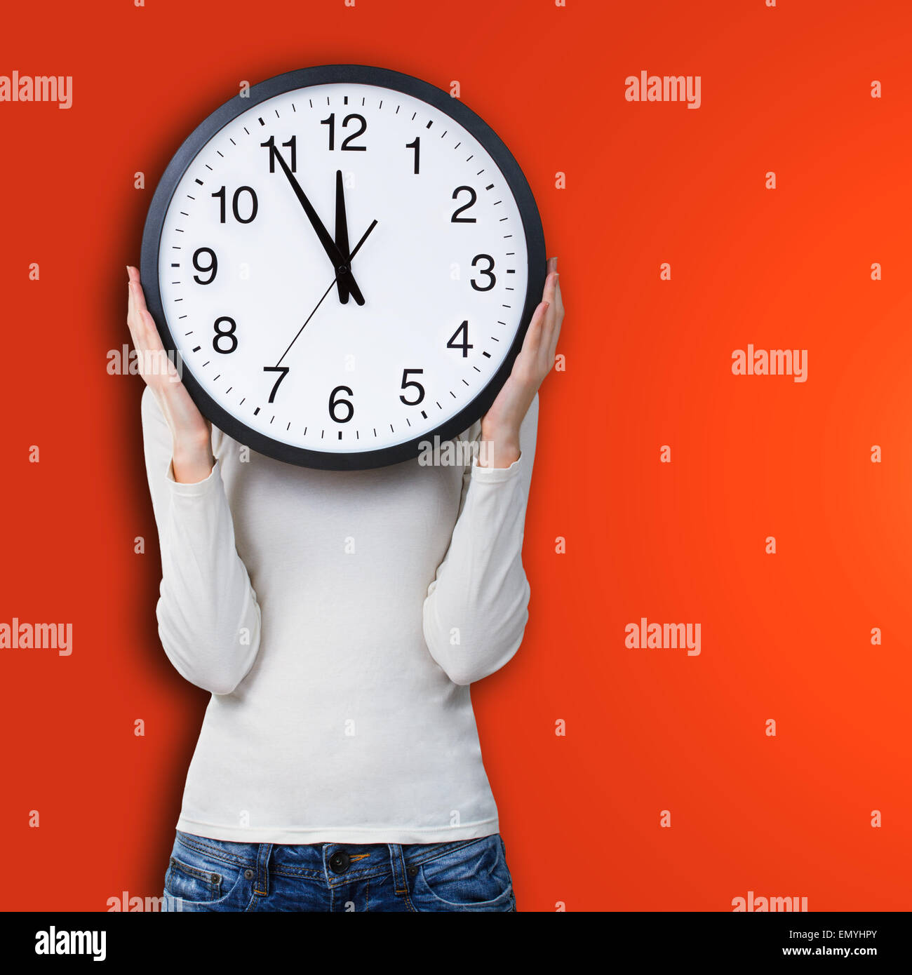 Woman holding clock over face hi-res stock photography and images - Alamy